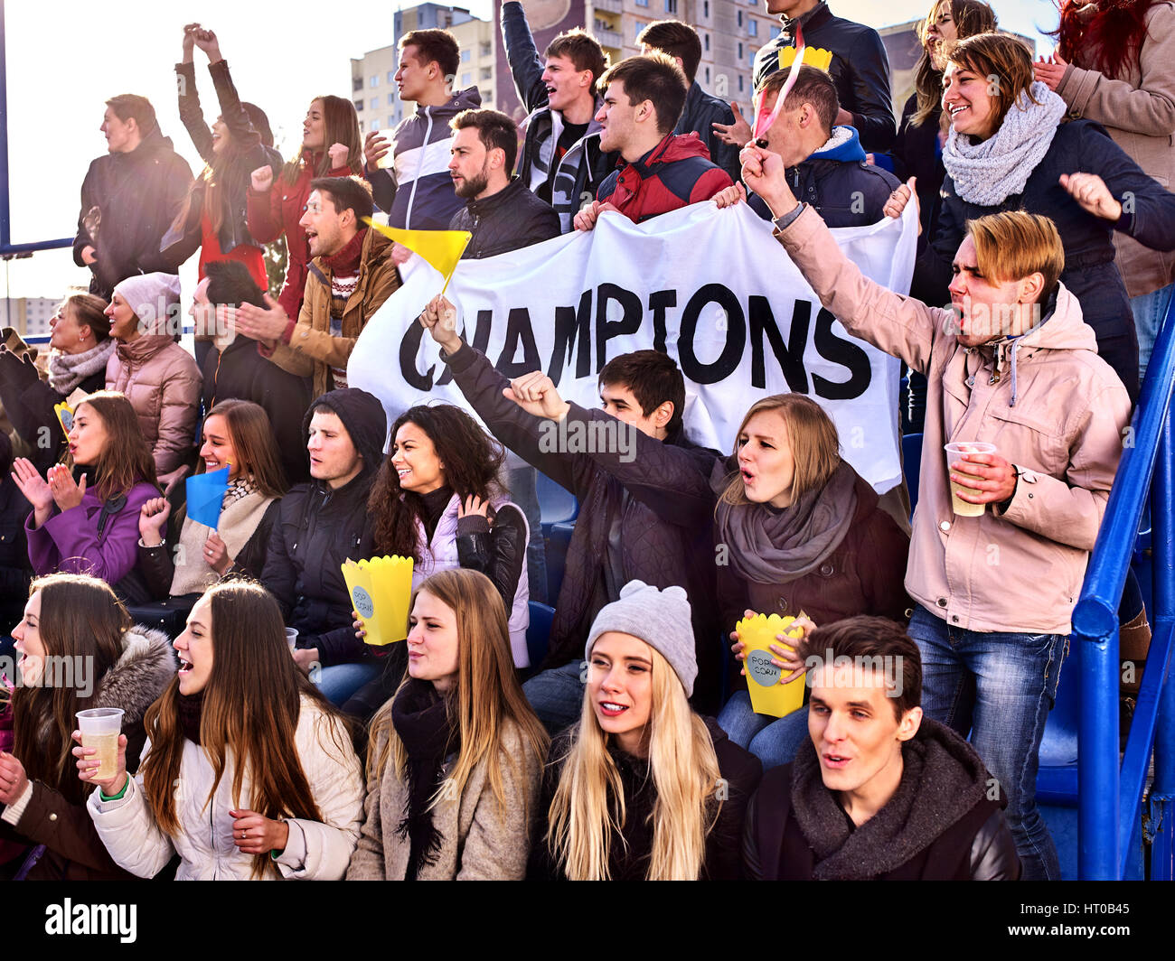 Cheering fans in stadium holding champion banner Stock Photo - Alamy