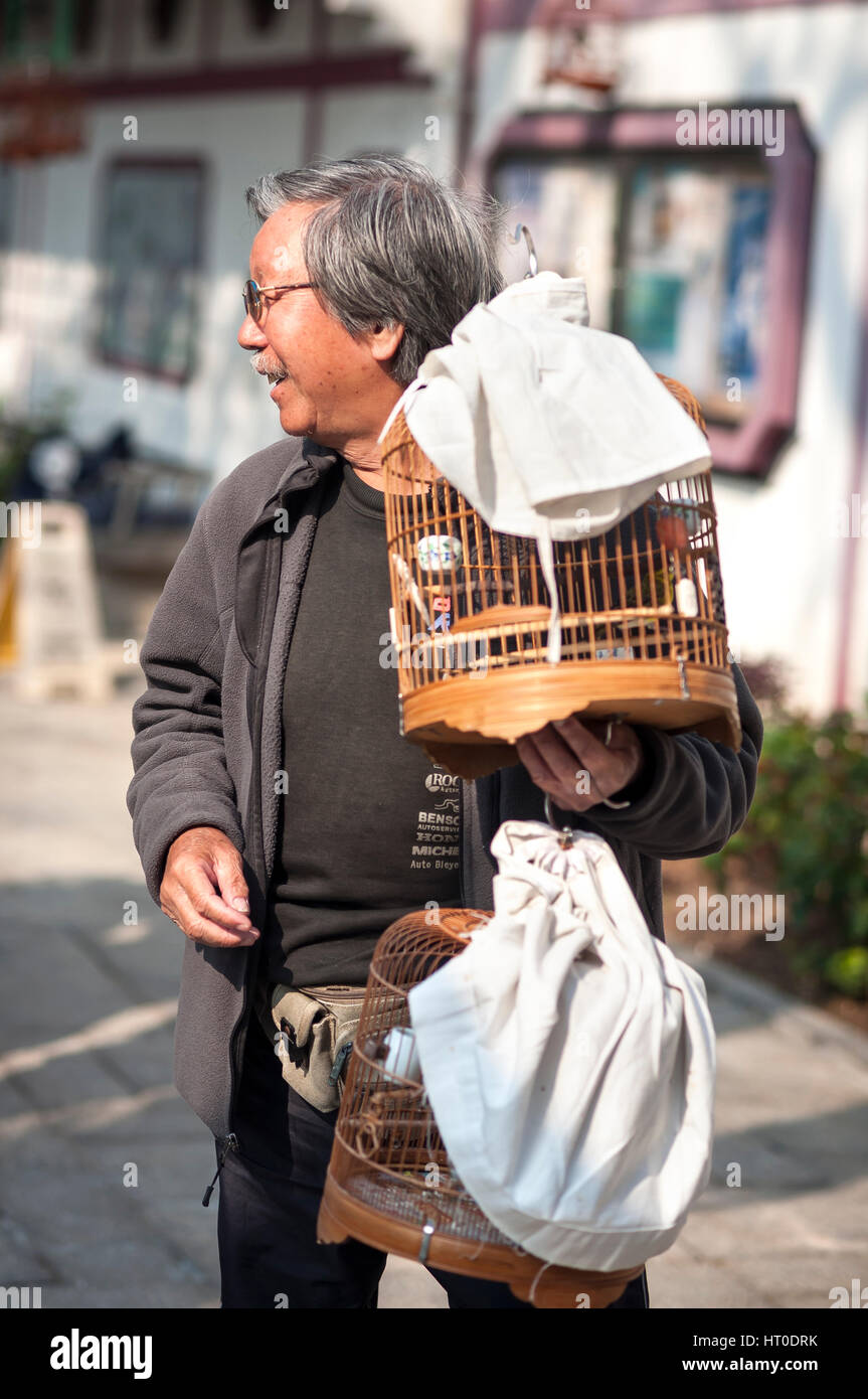 Chinese man with a bird cage hi-res stock photography and images - Alamy