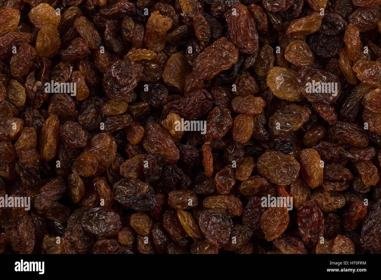 Sweet dry raisins close up shot for background Stock Photo - Alamy