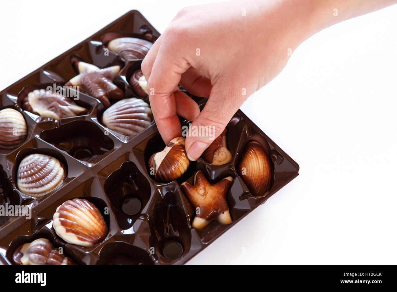 Woman hands taking chocolate candy in box Stock Photo - Alamy