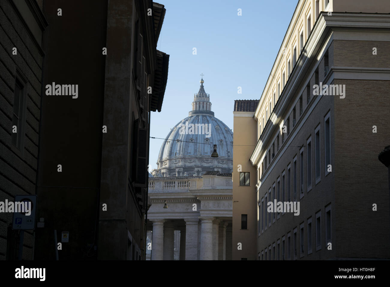 Saint Peter's dome in Rome seen through a typical roman alley Stock ...