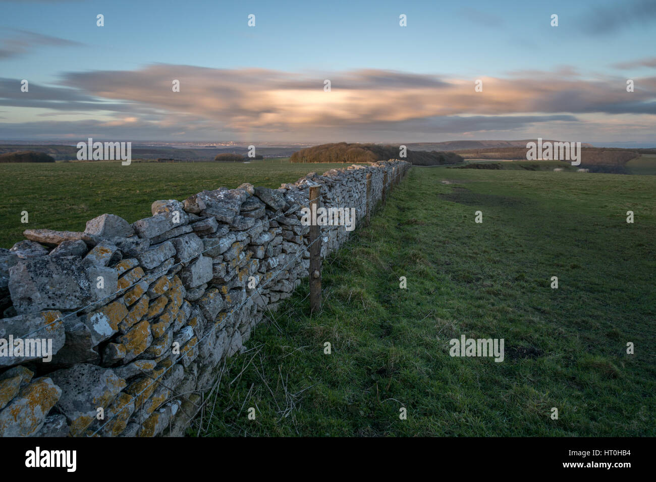 long stone wall down farmers field on hill at sunset Stock Photo - Alamy