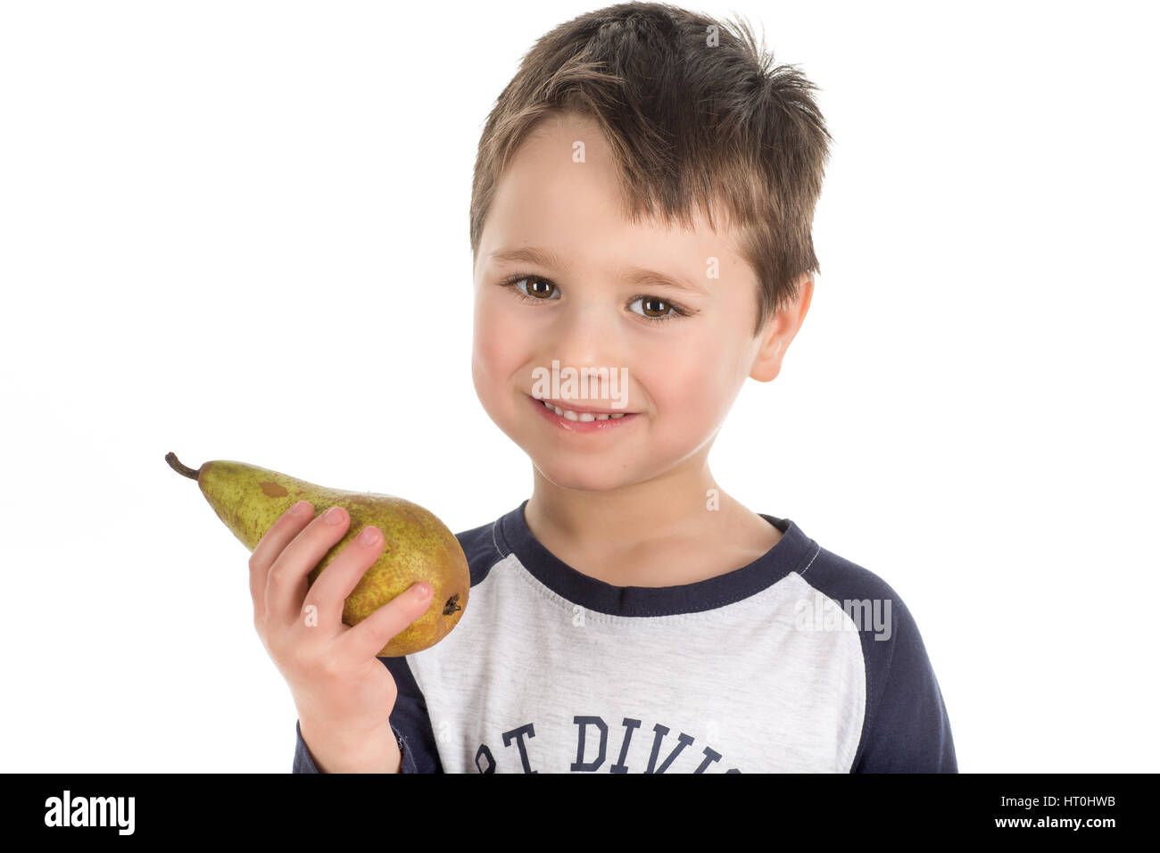 Smiley happy little boy holding a pear in his hand. Isolated on a white ...