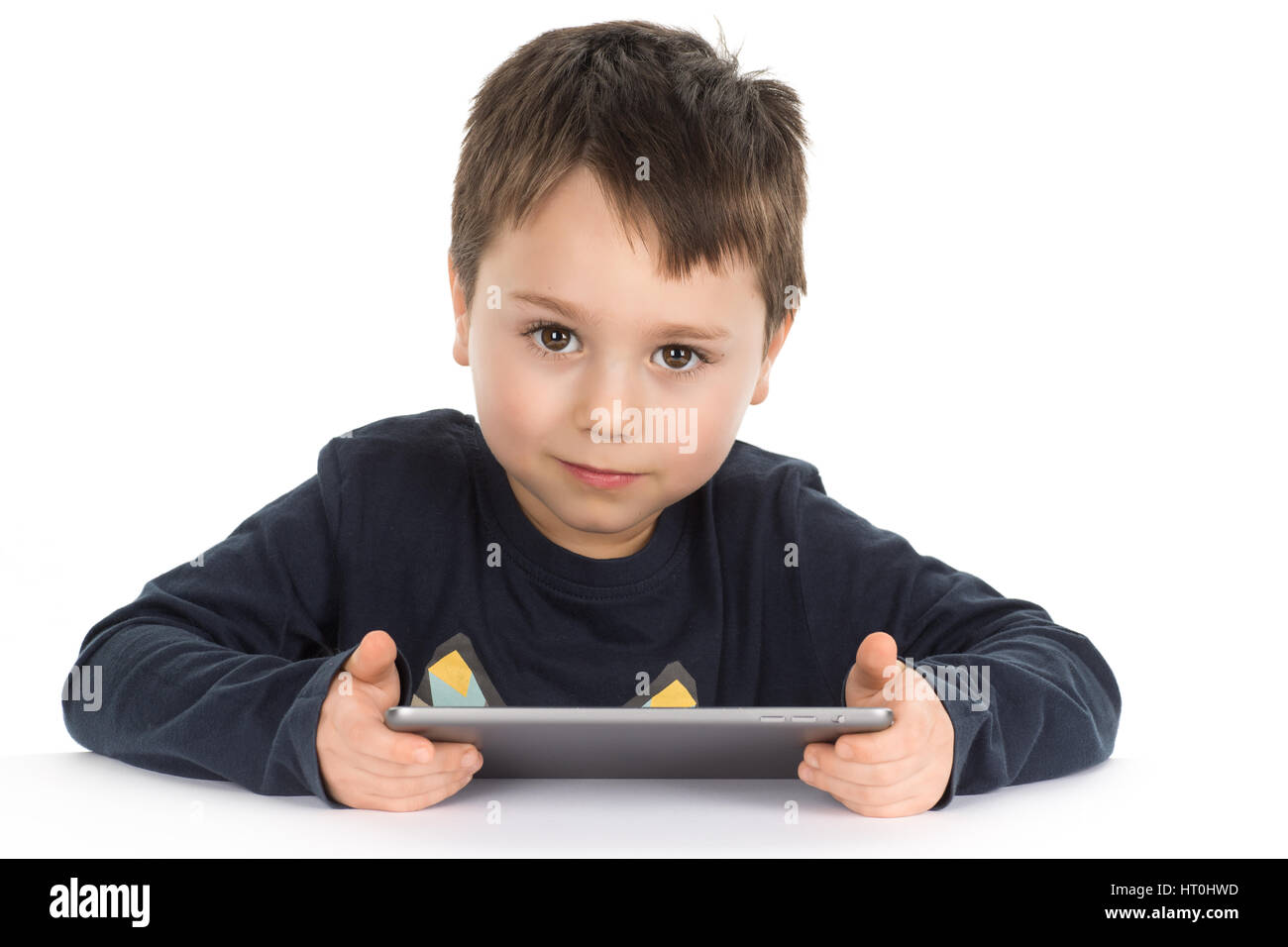 Little boy holding a tablet. Isolated on a white background Stock Photo ...