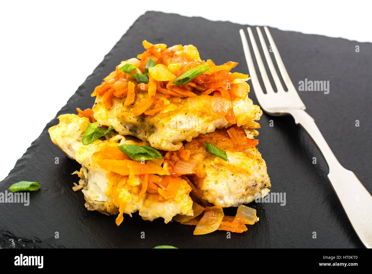 Greek style roast fish on black stone plate Stock Photo - Alamy