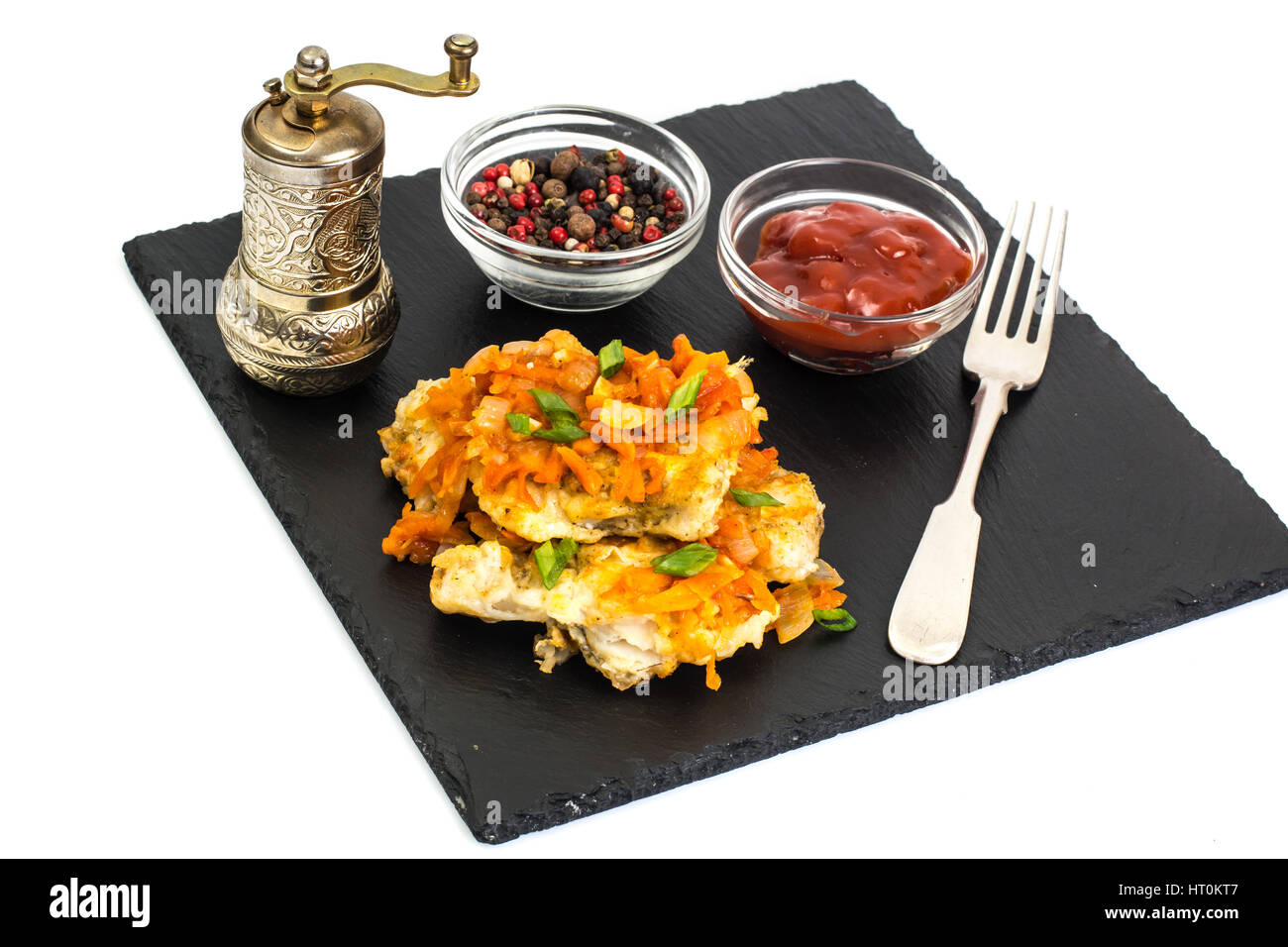 Greek style roast fish on black stone plate Stock Photo - Alamy