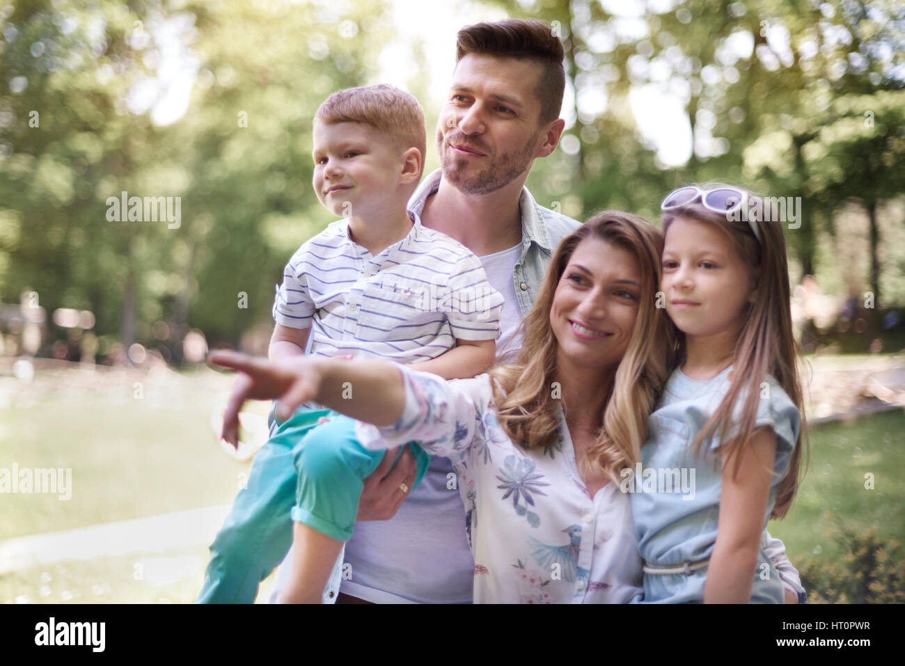 Happy family watching wild animal at the zoo Stock Photo - Alamy