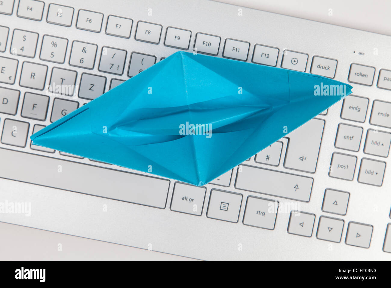 Paper ship on keyboard hi-res stock photography and images - Alamy