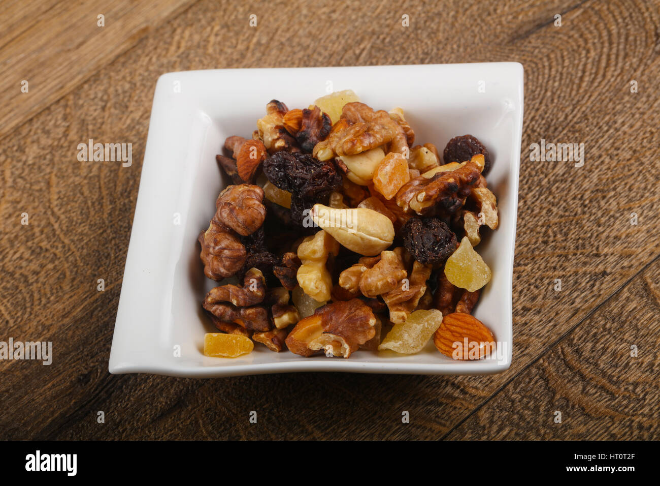 Nut mix heap in the bowl over wood background Stock Photo - Alamy