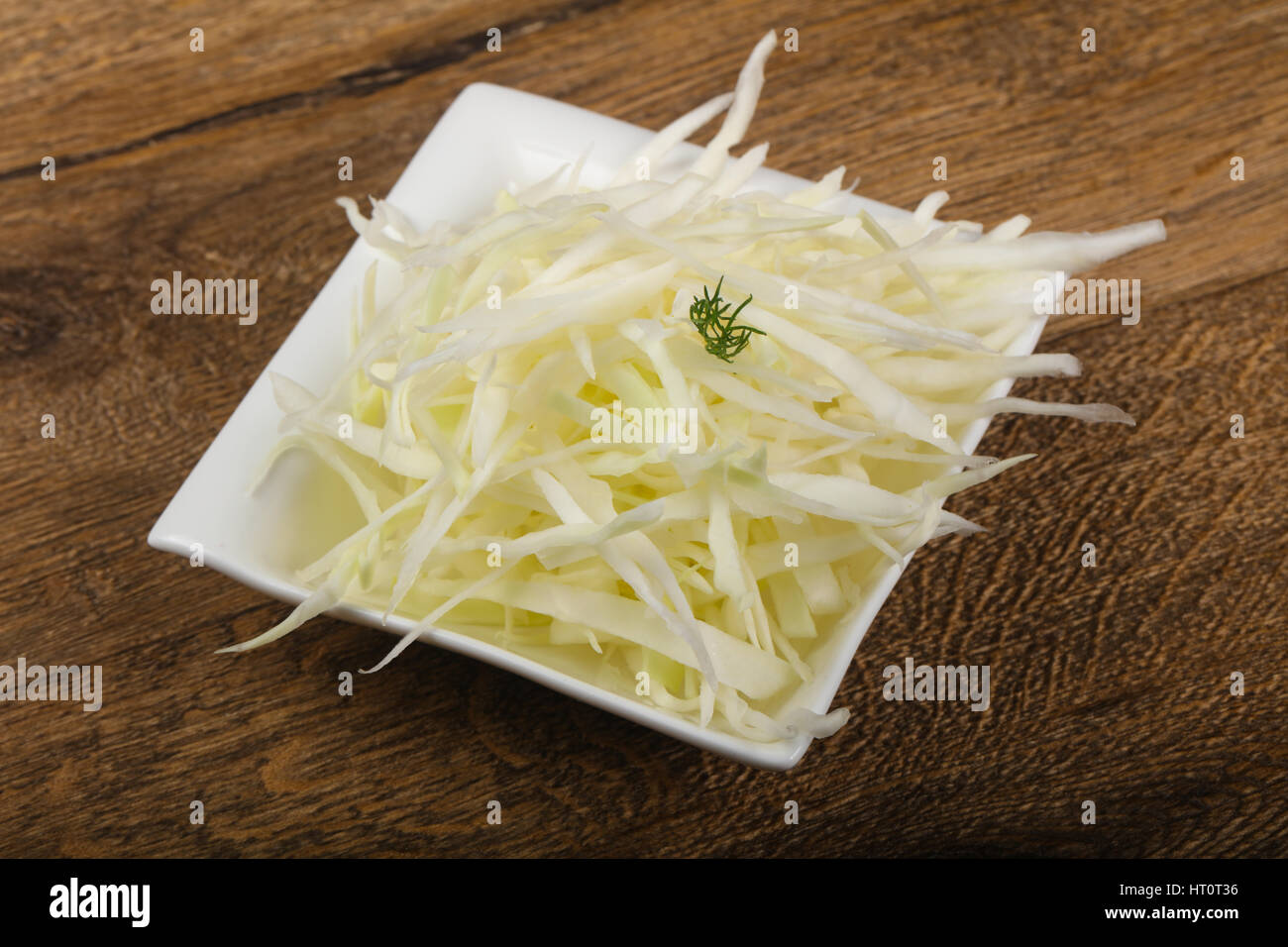 Shredded cabbage heap in the bowl ower wooden background Stock Photo ...