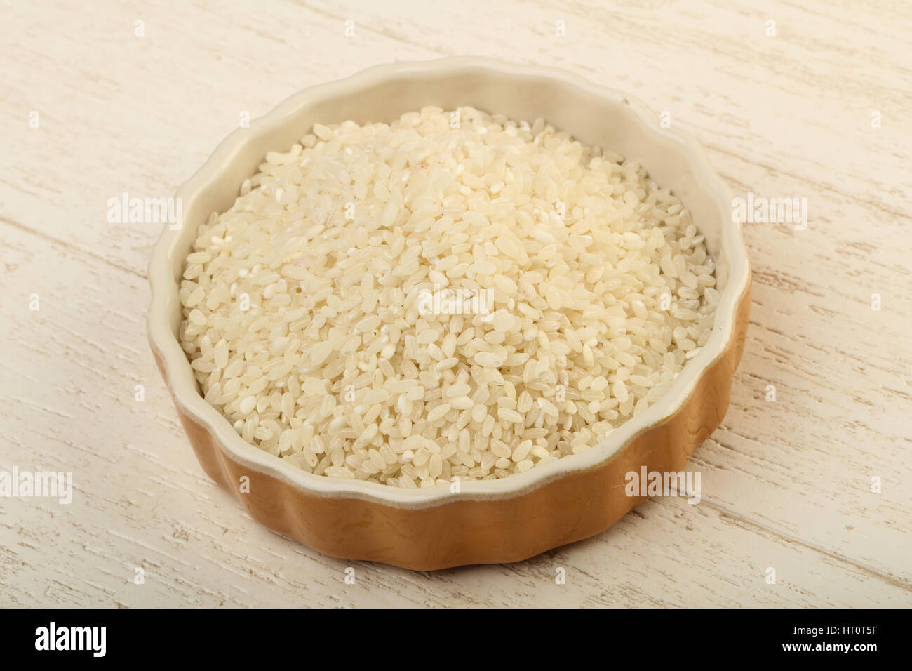 Raw rice heap in the bowl - ready for cooking Stock Photo - Alamy