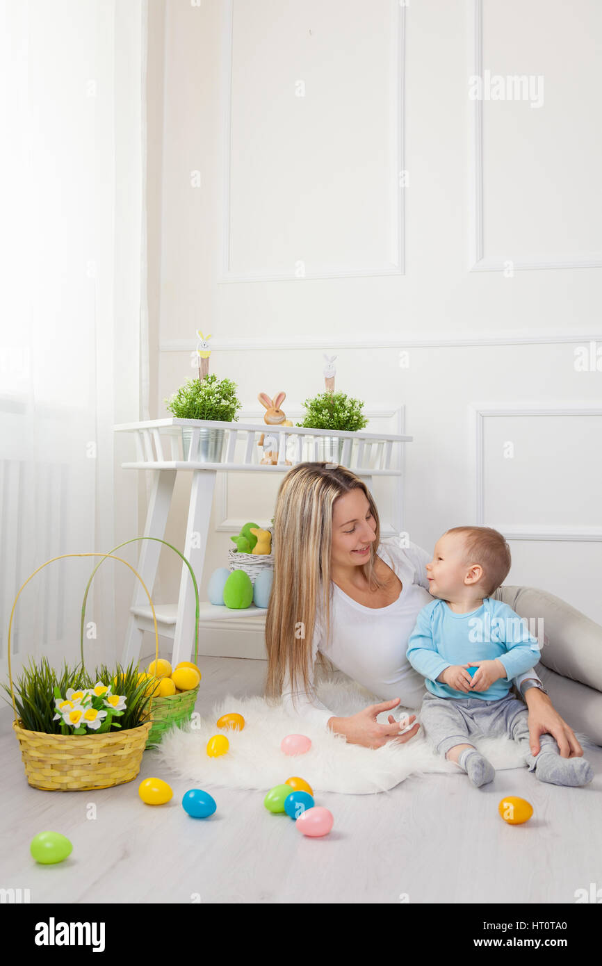 Delighted mother and her little child enjoying the Easter egg hunt at ...