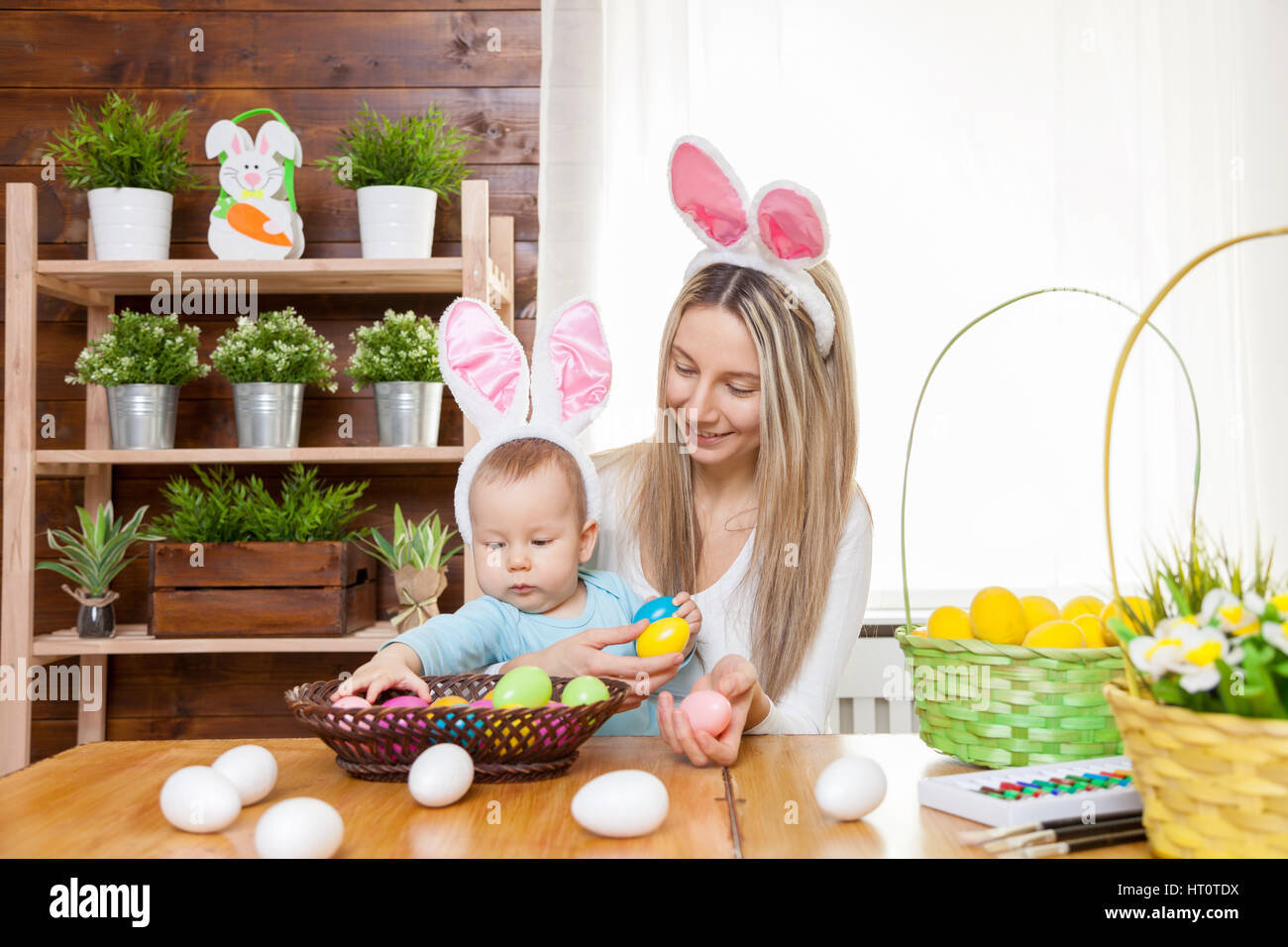 Easter concept. Happy mother and her cute child wearing bunny ears ...