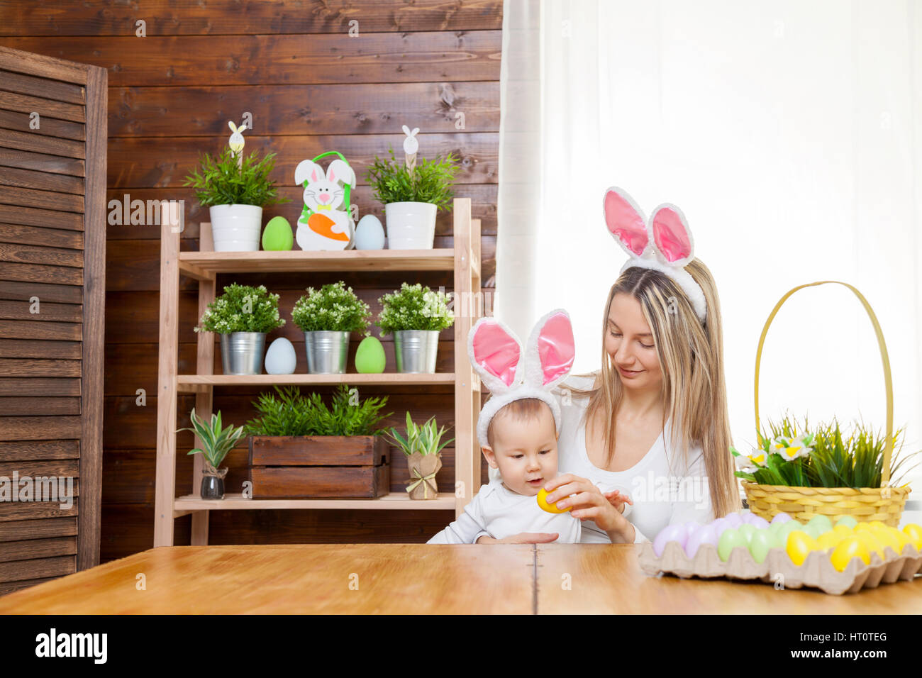 Easter concept. Happy mother and her cute child wearing bunny ears ...