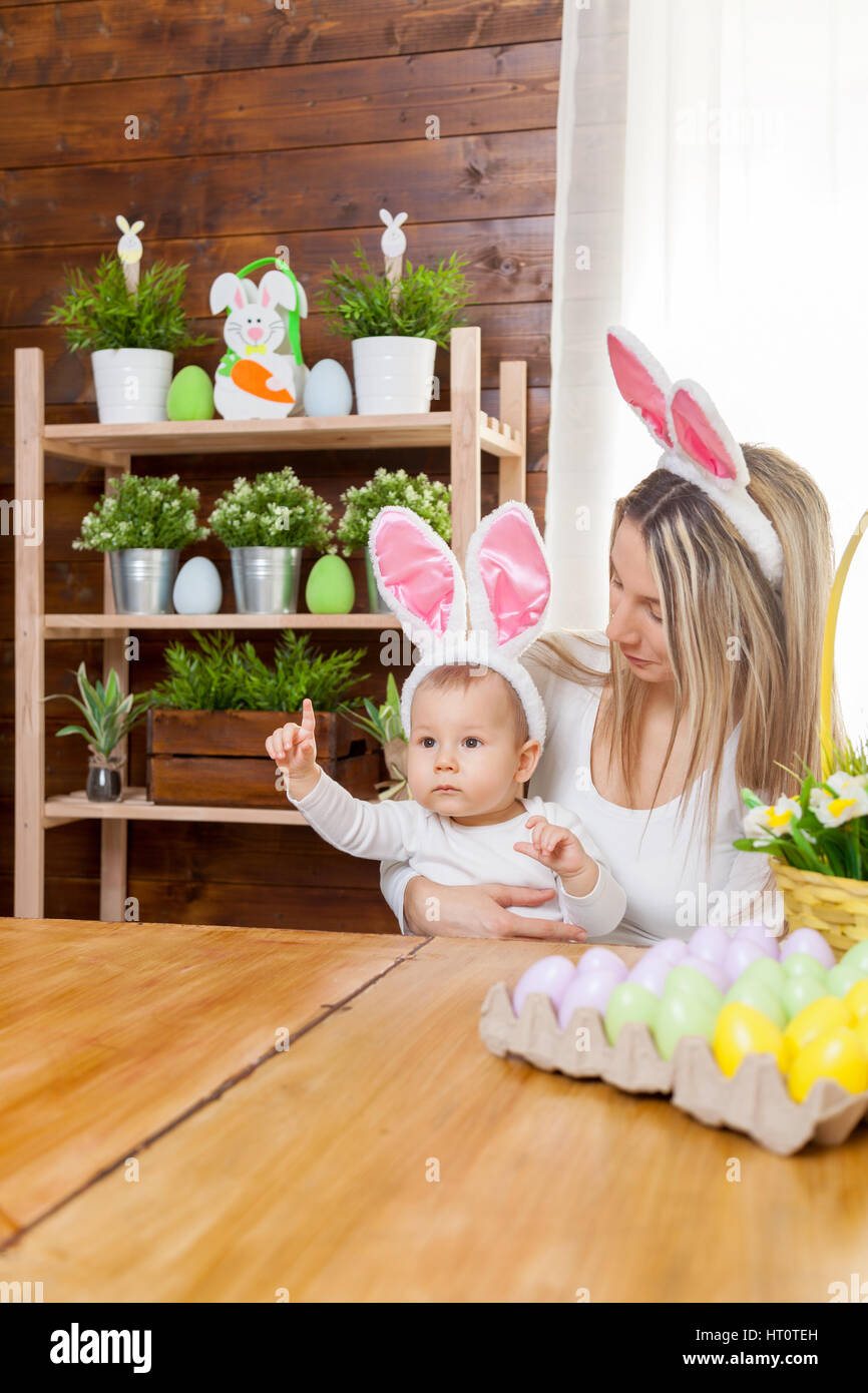 Easter concept. Happy mother and her cute child wearing bunny ears ...