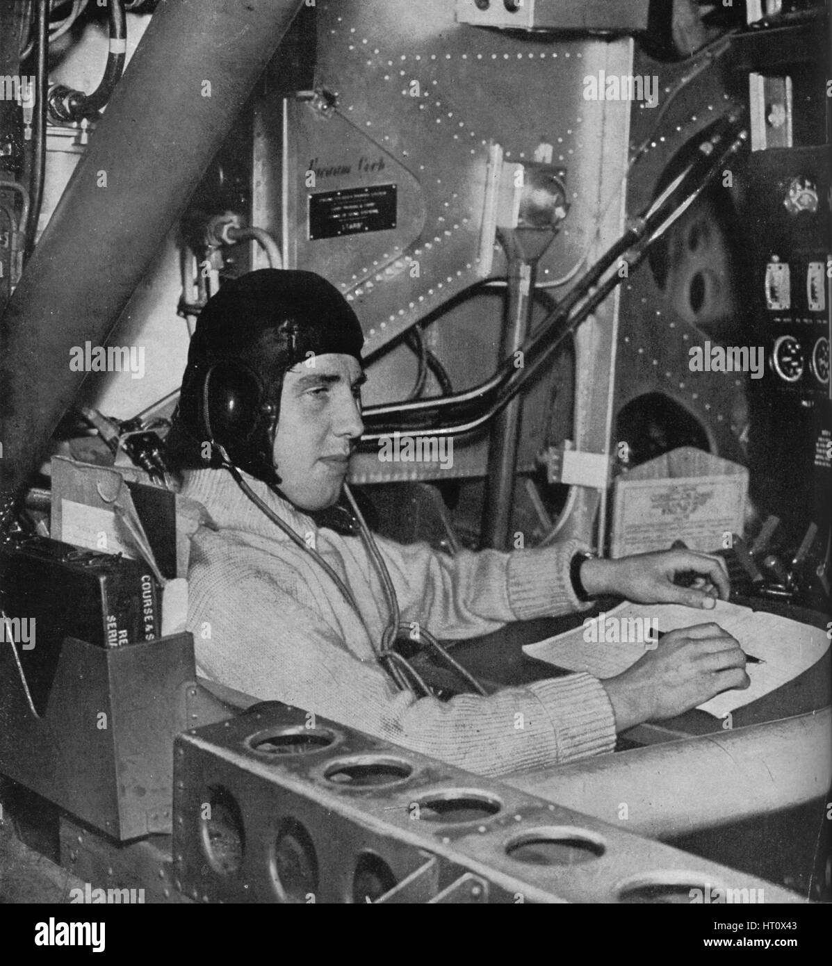 RAF flight engineer on board an aircraft, c1940 (1943). Artist: Unknown ...