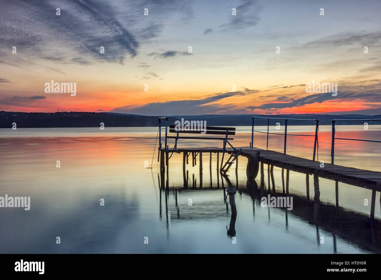 Beautiful long exposure sunset view with bench on wooden bridge Stock ...