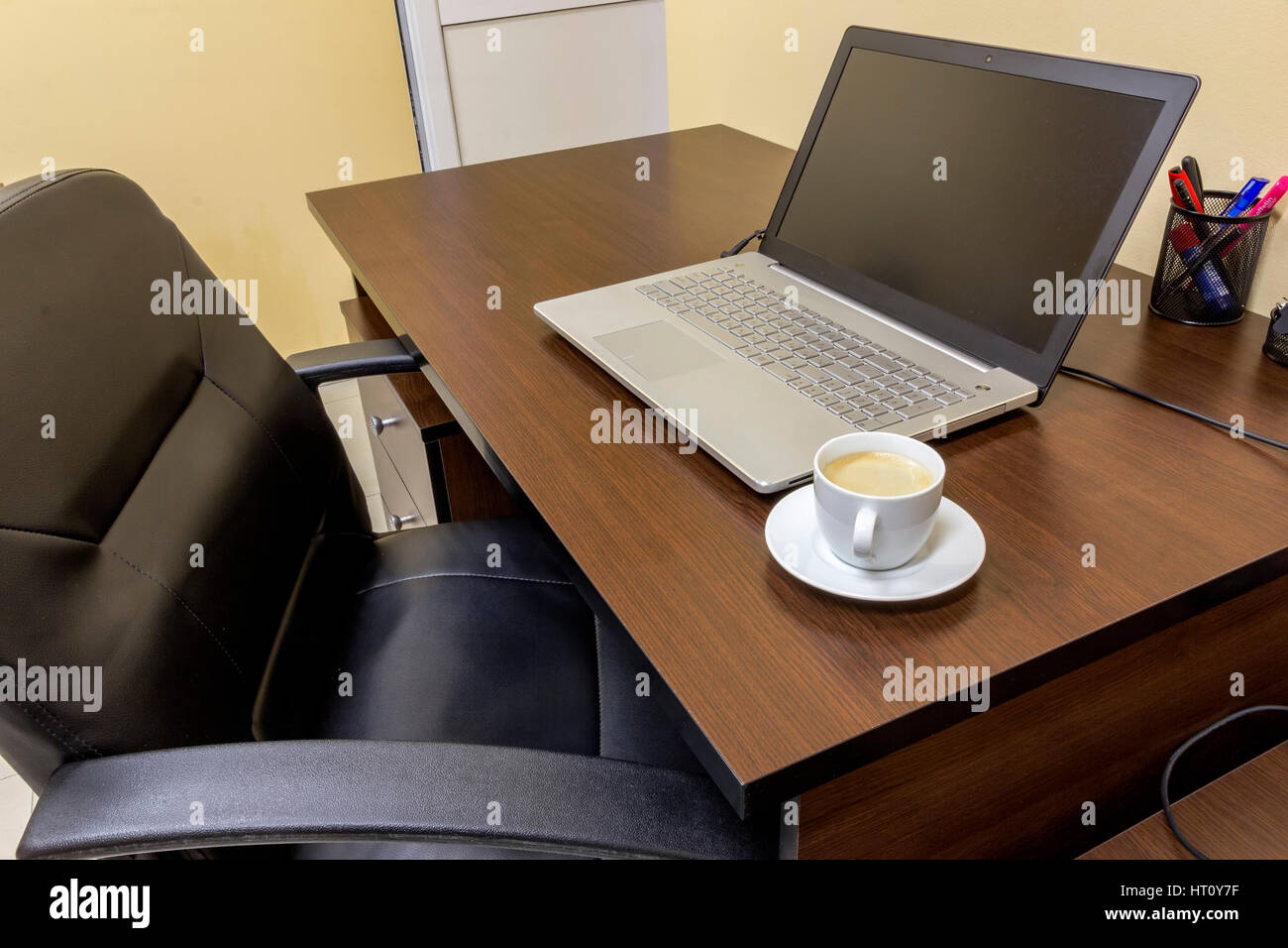 Comfortable working place in office with wooden table,black leather ...
