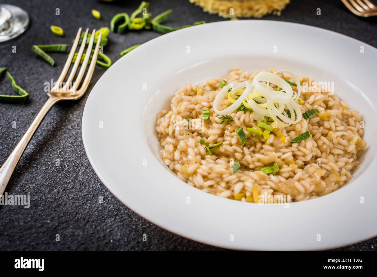 Italian rice arborio risotto with leek on white table Stock Photo - Alamy