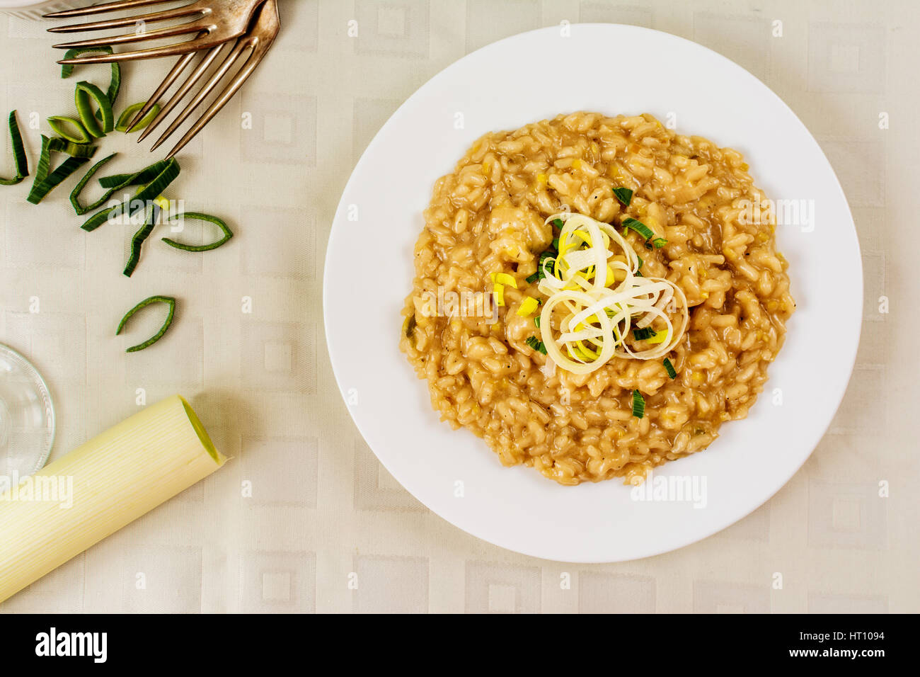 Italian rice arborio risotto with leek on white table Stock Photo - Alamy