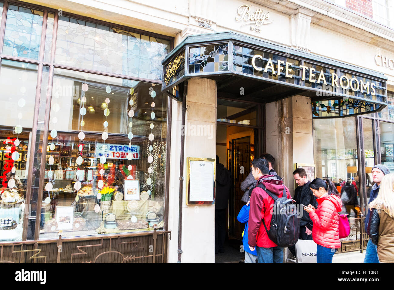 Bettys Café Tea Rooms customers queue queuing outside shop waiting for ...