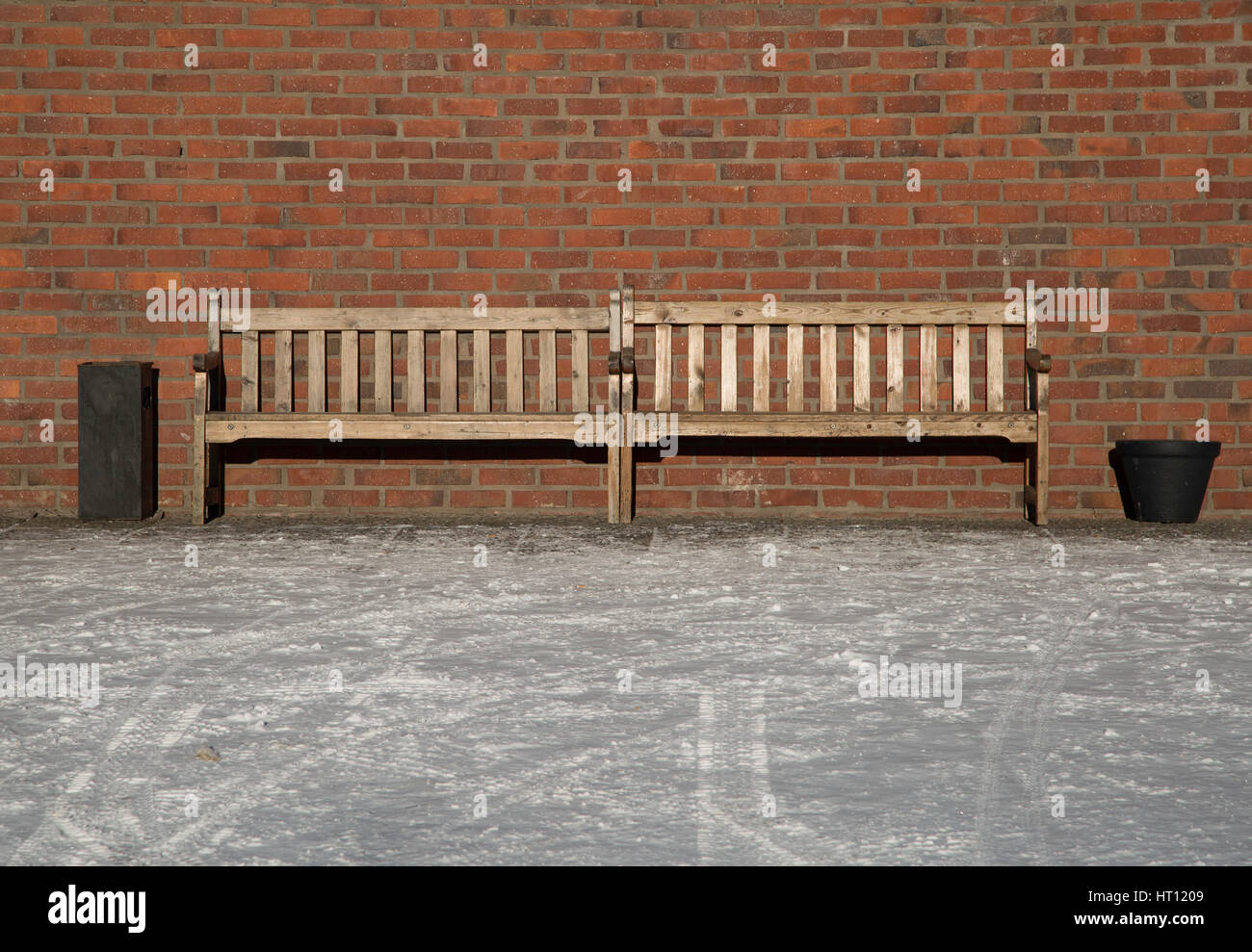 Pair of Benches by brick wall Stock Photo - Alamy