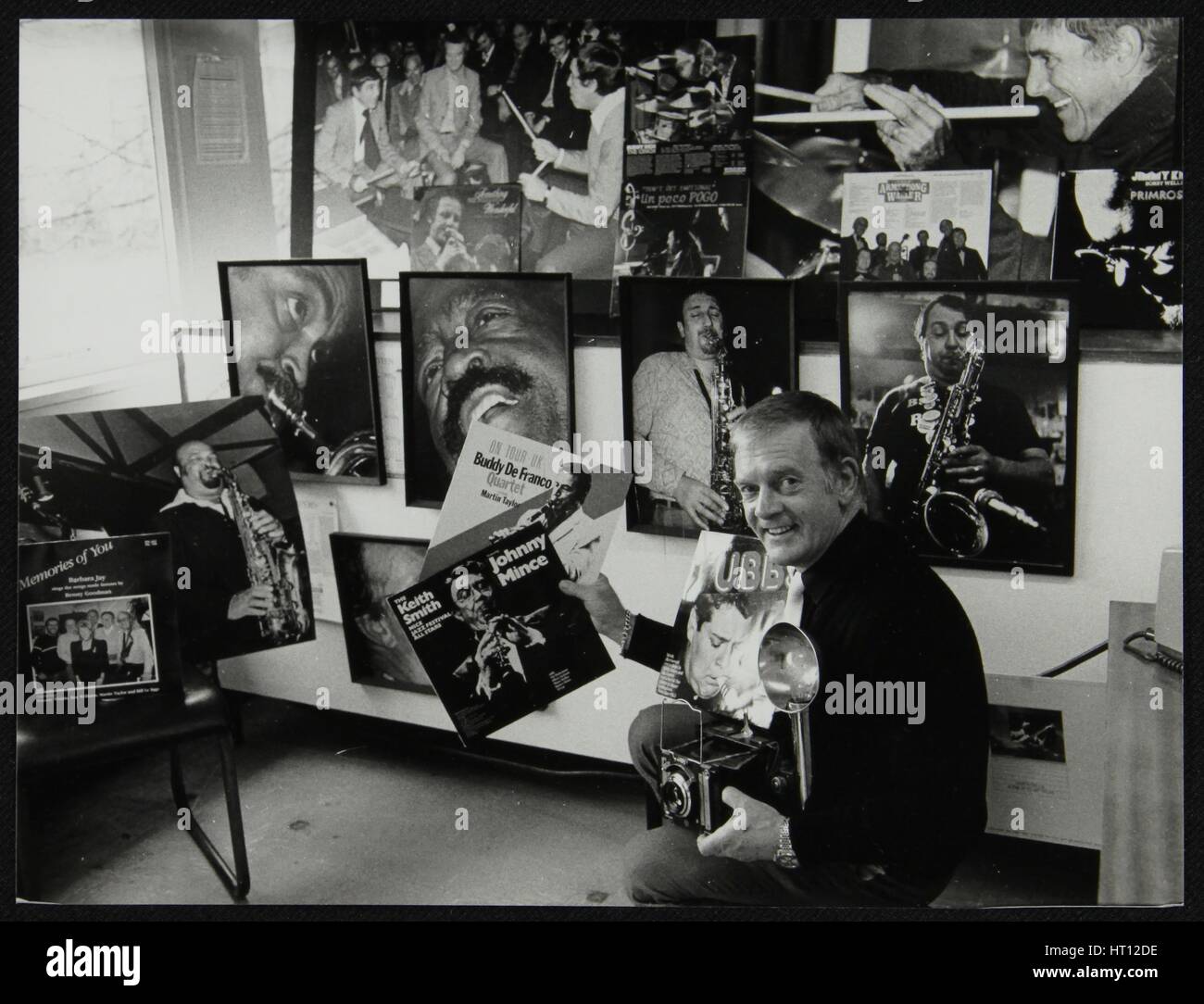 Photographer Denis Williams holding an LP cover. Artist: Unknown Stock ...
