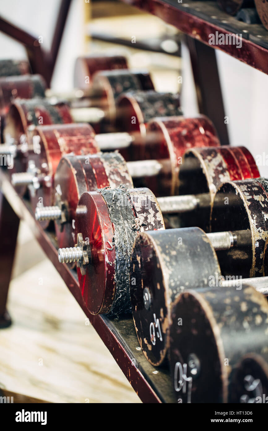 Gym equipment background with close up selective focus to a dumbbell ...