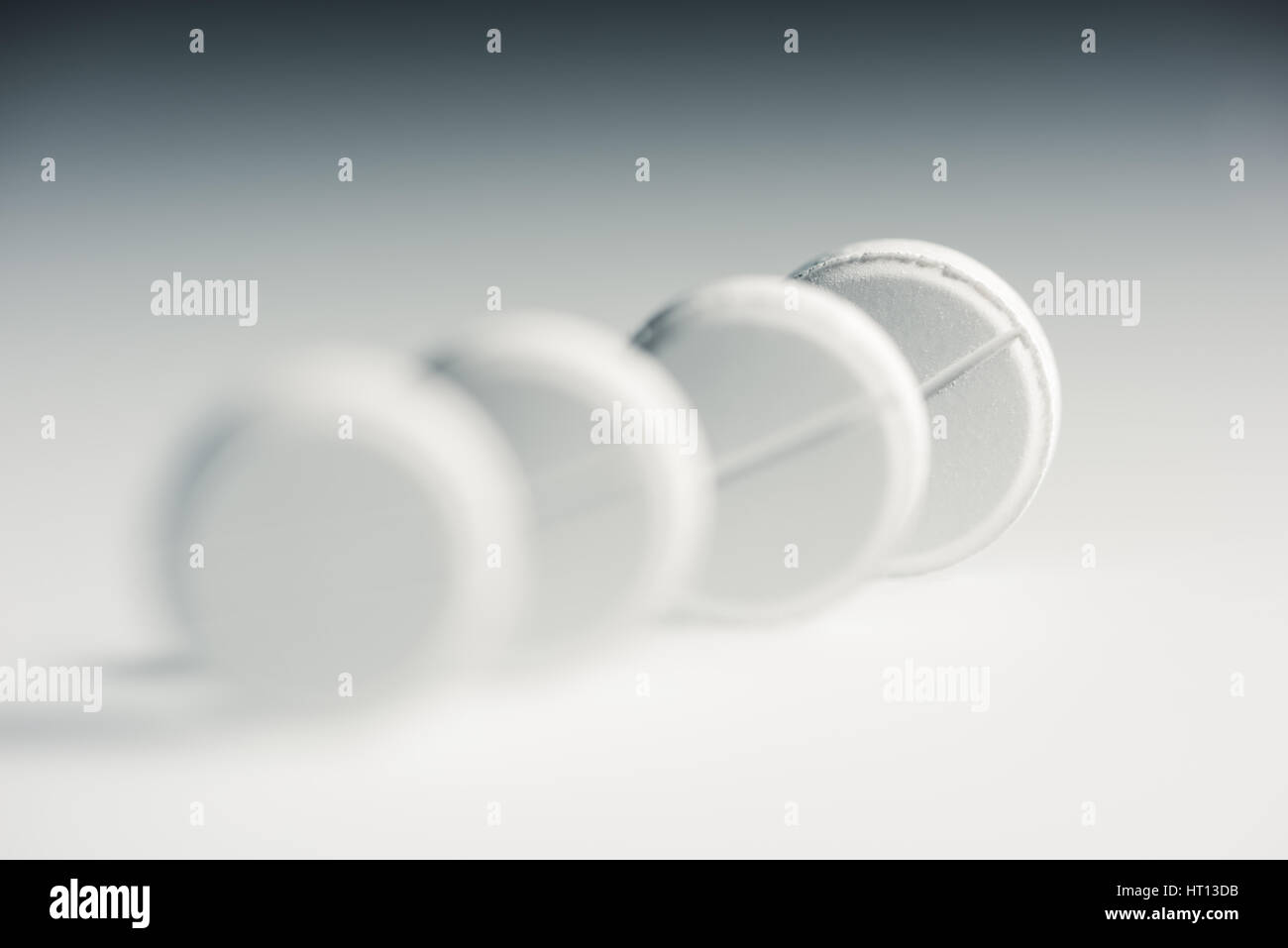 Close-up view of round white medical tablets in row, medicine and ...