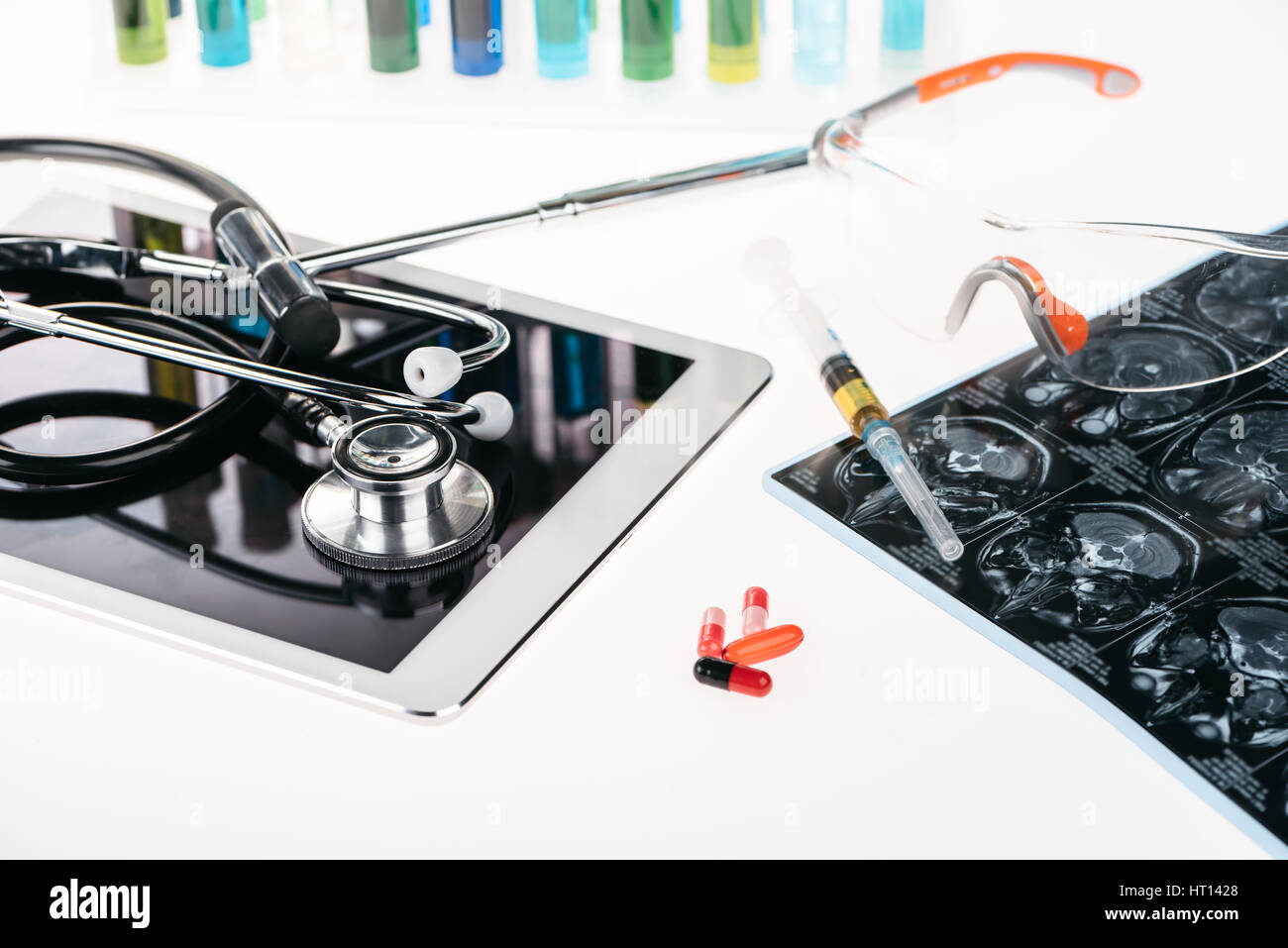 close up view of medical equipment on tablet, x-ray picture and pills ...