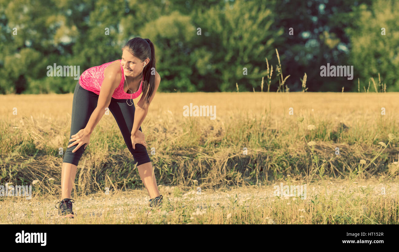 Attractive female stretching before jogging Stock Photo - Alamy
