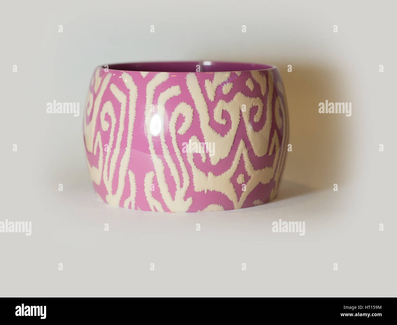 White pink plastic bracelet on a white background ethnic Stock Photo ...