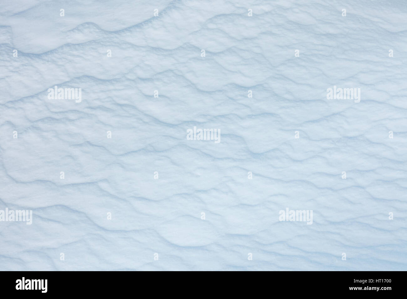 wavy texture snow-covered surface. Winter background Stock Photo - Alamy
