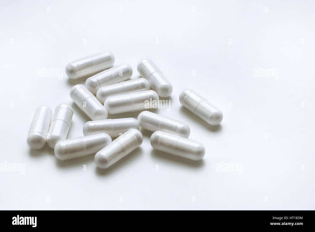 White medicine capsules isolated on white background. Copy space. High ...