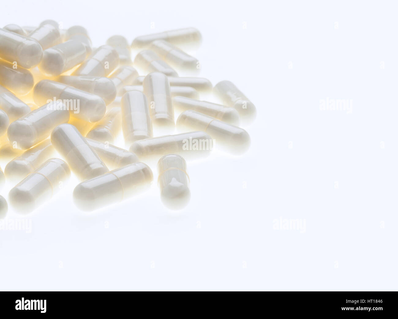Many white glowing capsules on white background. Copy space. High ...