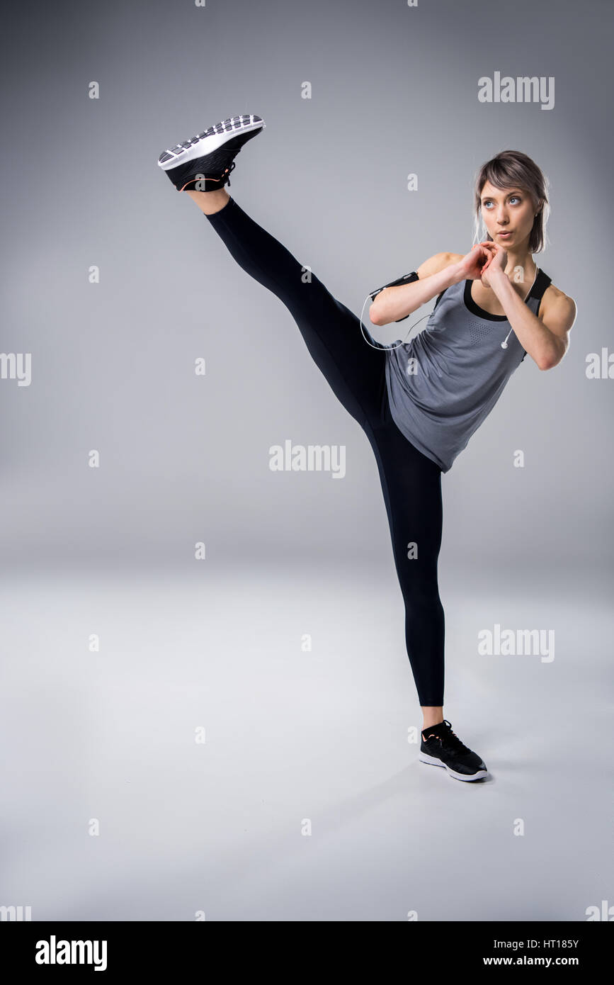 Athletic woman training high kick hi-res stock photography and images ...