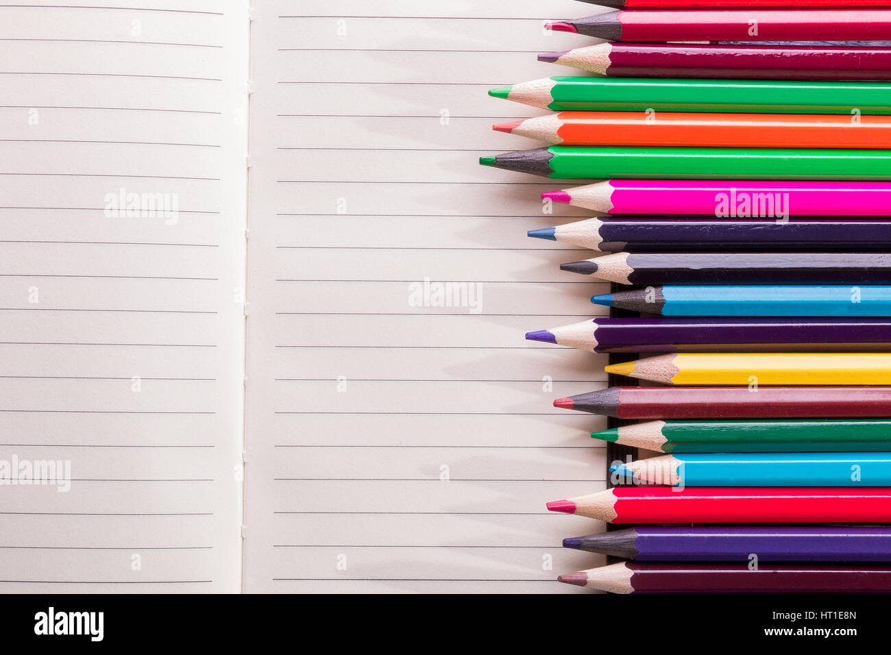 Color pencils on note background. Top view Stock Photo - Alamy
