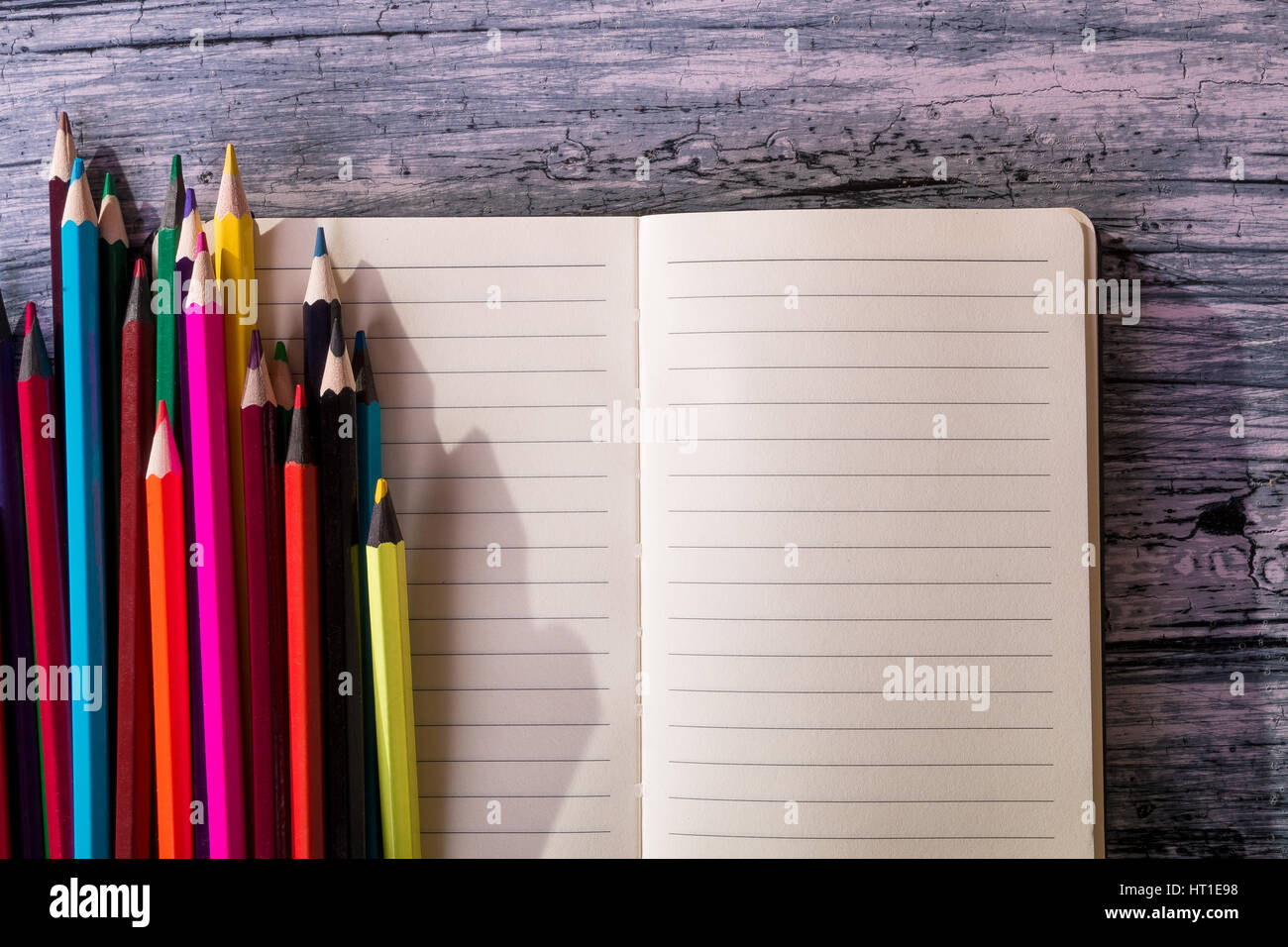 Color pencils on note background. Top view Stock Photo - Alamy