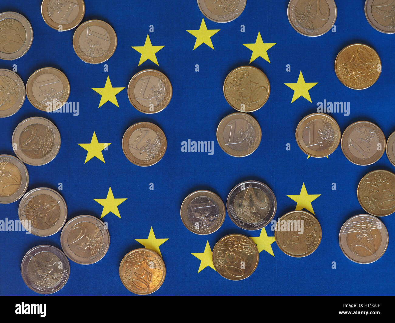 Euro coins (EUR), currency of European Union over flag of Europe Stock ...