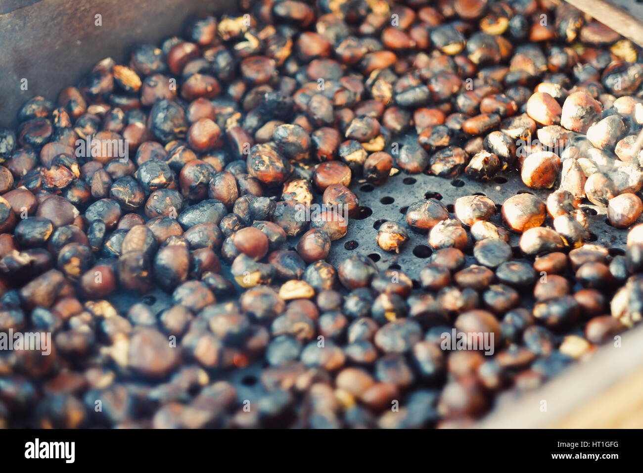 Roasting chestnut on street in the charcoal burner Stock Photo - Alamy