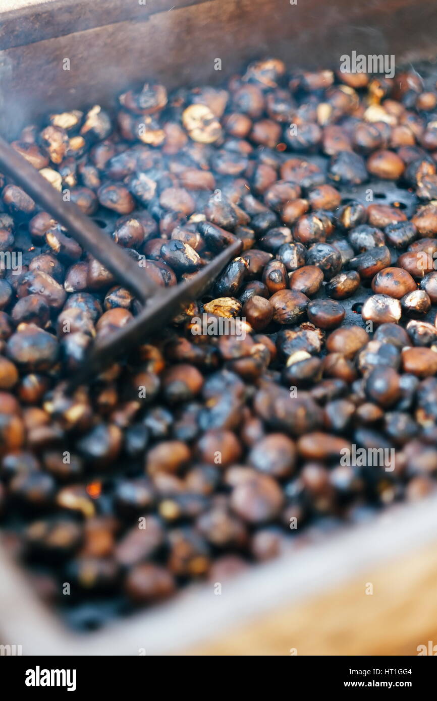 Roasting chestnut on street in the charcoal burner Stock Photo - Alamy