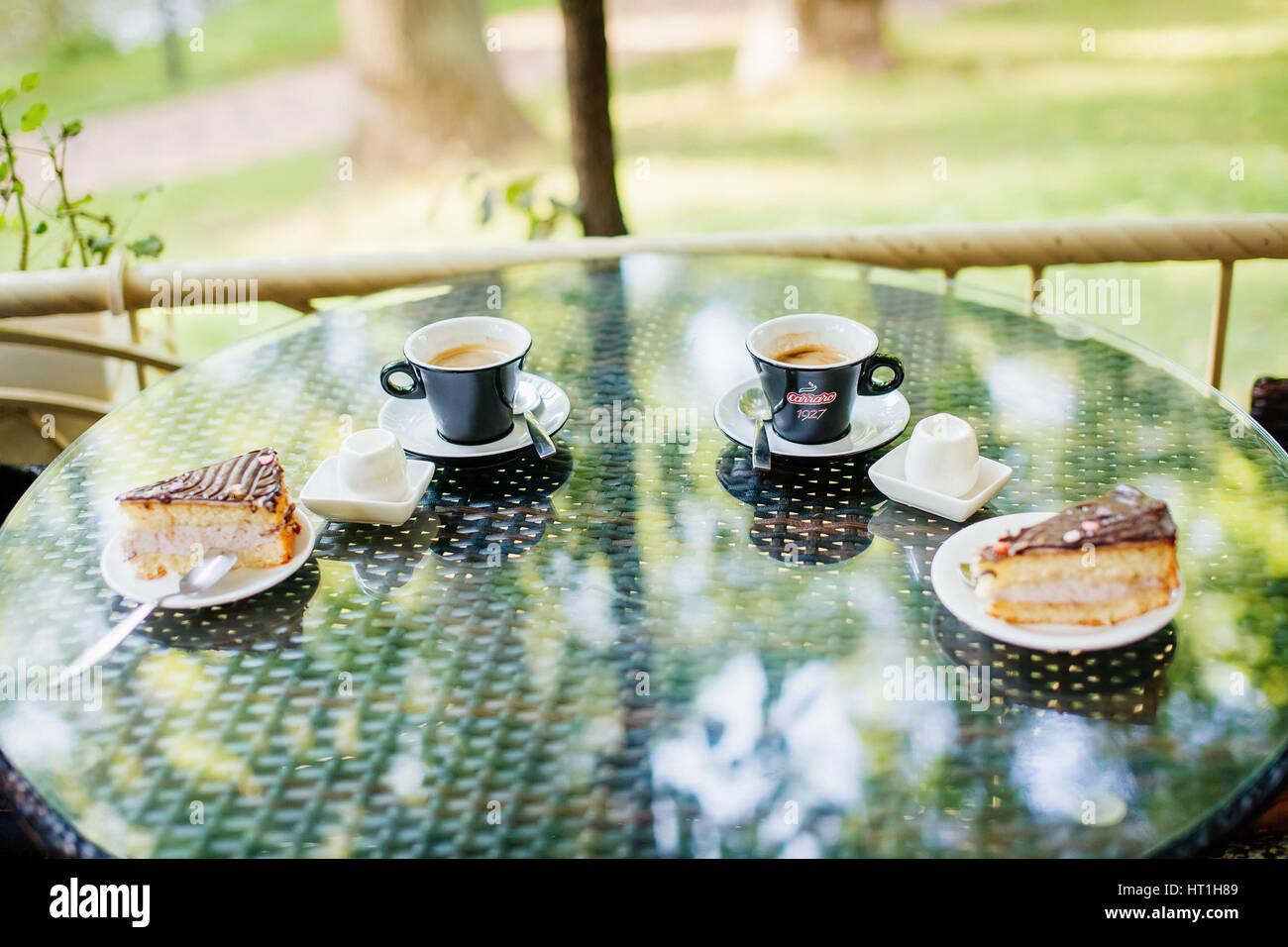 coffee for two with cake in cafe. Cafe in park outdoors Stock Photo - Alamy