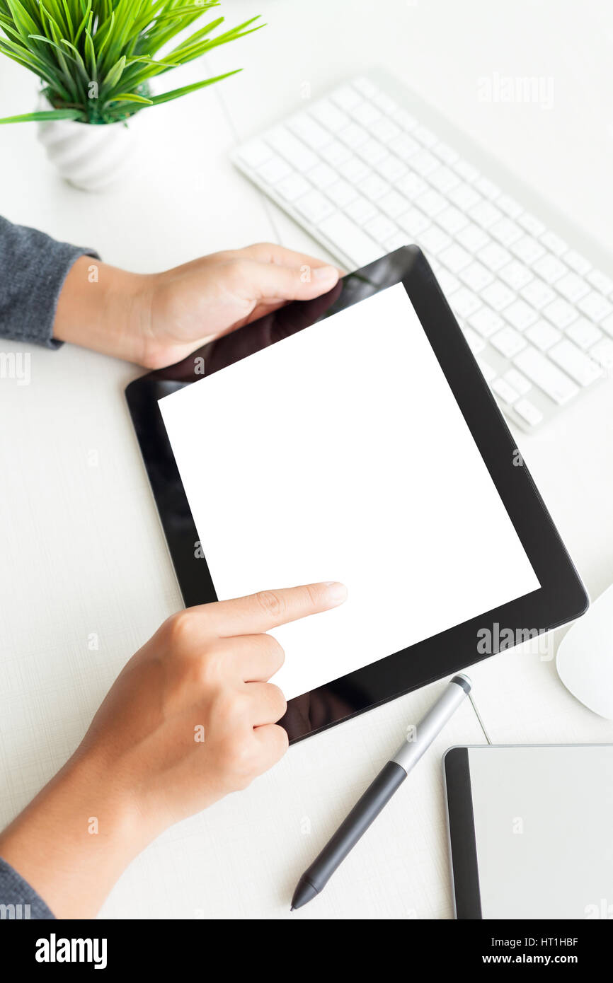 hand using digital tablet on desk vertical view Stock Photo - Alamy