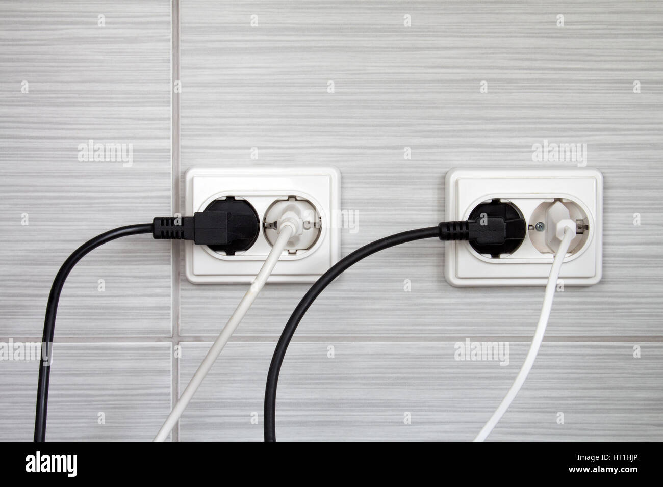 Electrical plugs connected into the wall sockets Stock Photo - Alamy