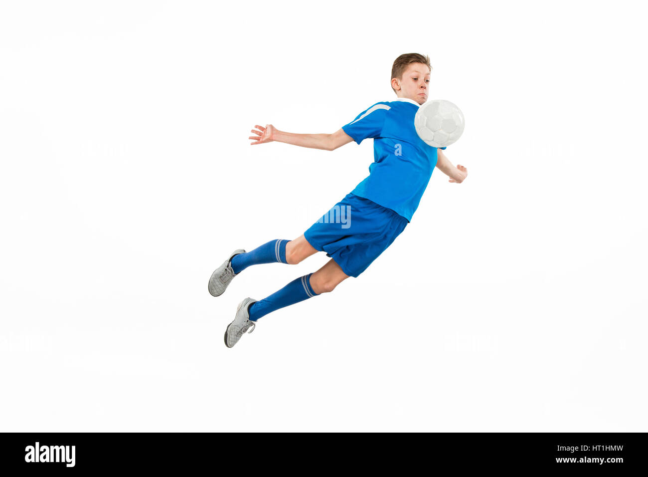 Young boy with soccer ball doing flying kick, isolated on white Stock ...