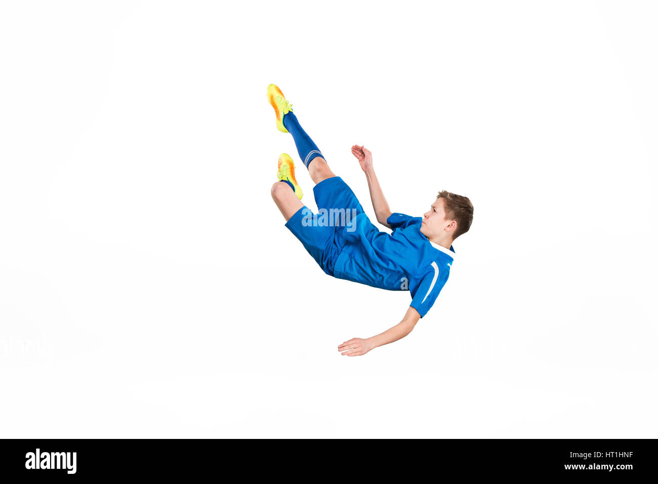 Young boy with soccer ball doing flying kick, isolated on white Stock ...