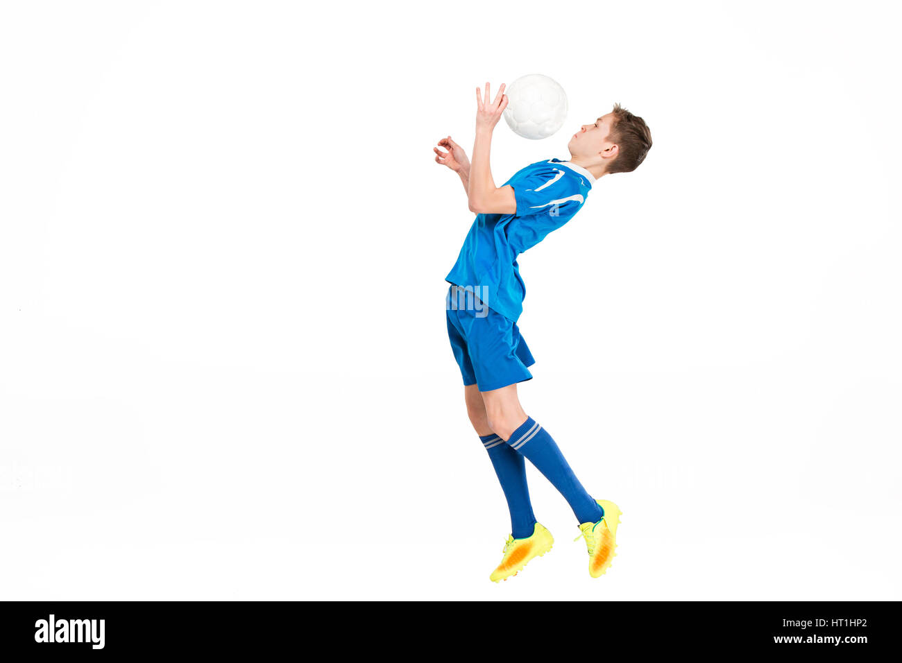 Young boy with soccer ball doing flying kick, isolated on white Stock ...