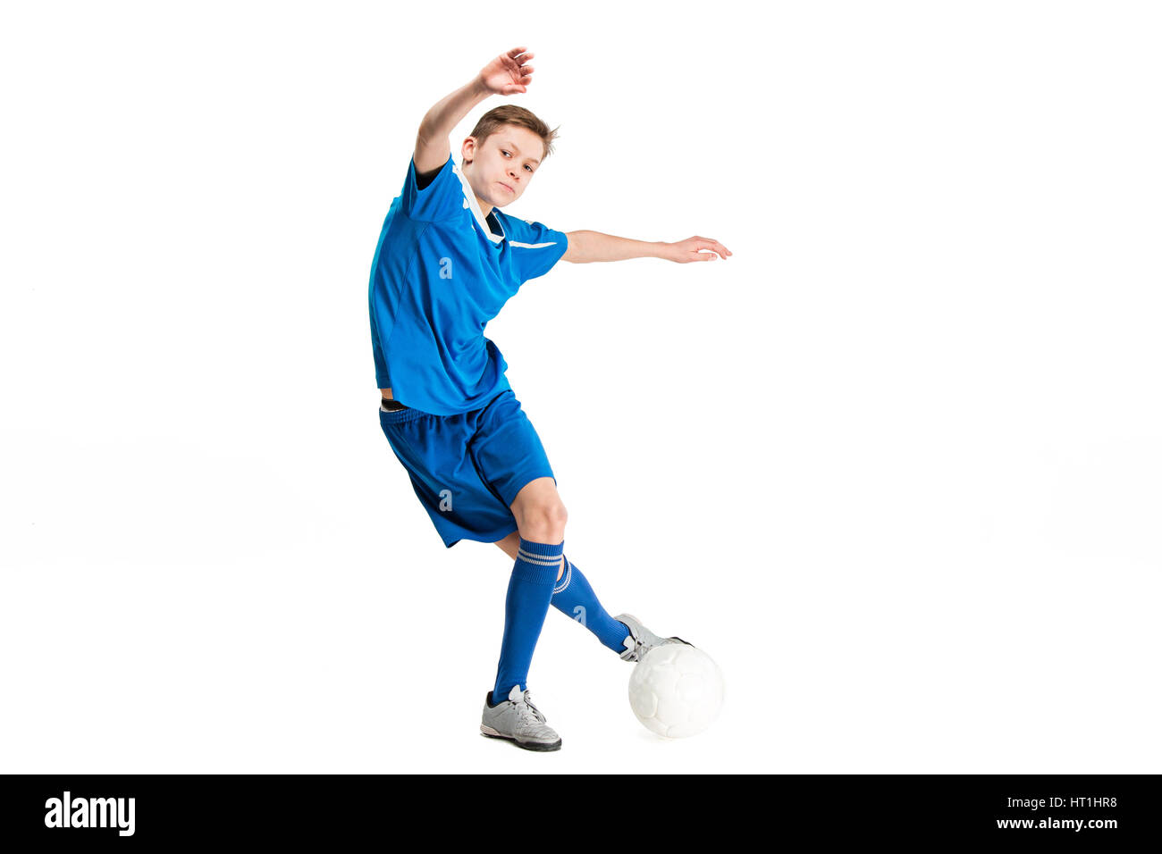 Young boy with soccer ball doing flying kick, isolated on white Stock ...