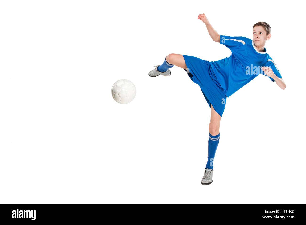 Young boy with soccer ball doing flying kick, isolated on white Stock ...