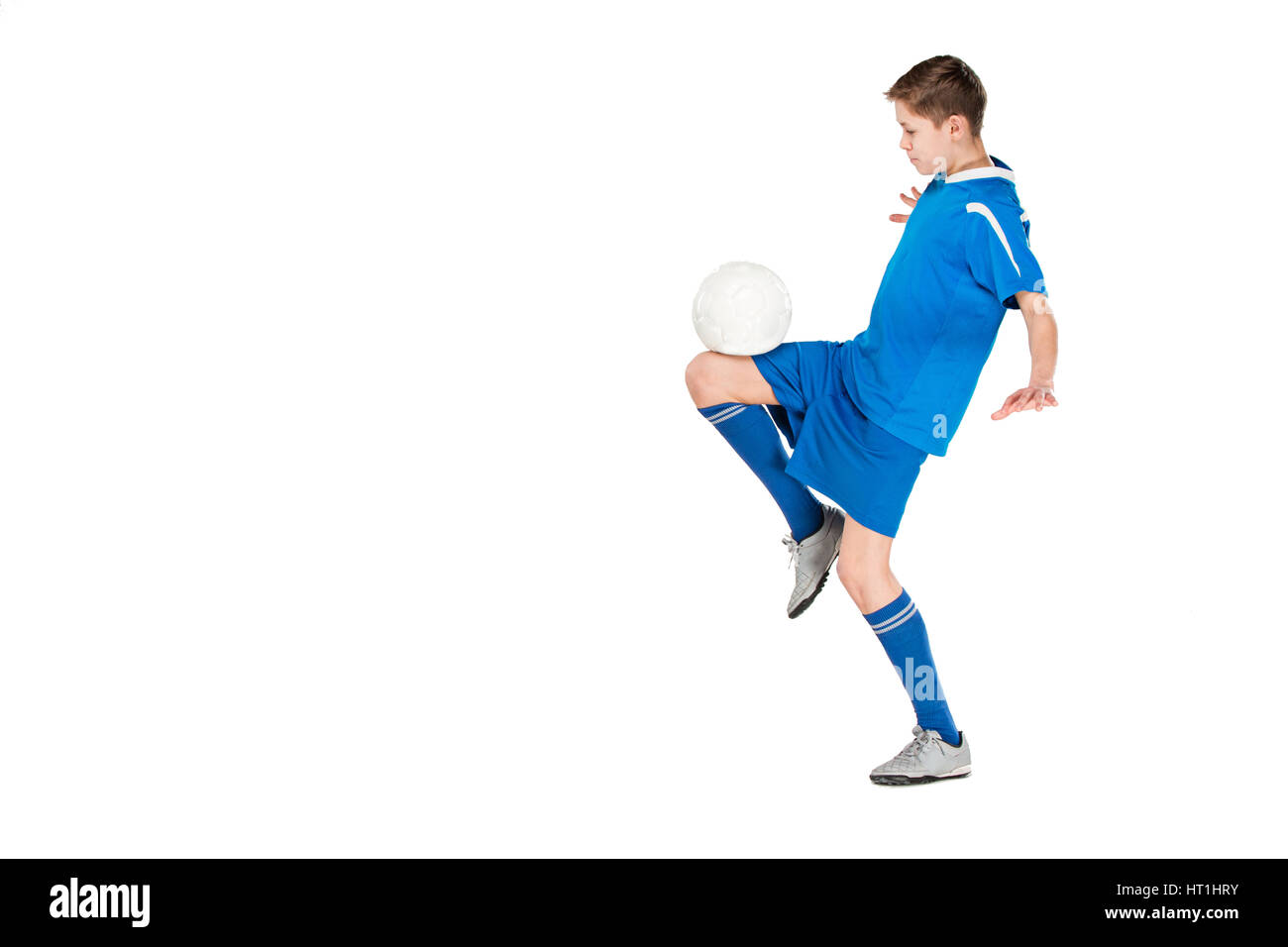 Young boy with soccer ball doing flying kick, isolated on white Stock ...